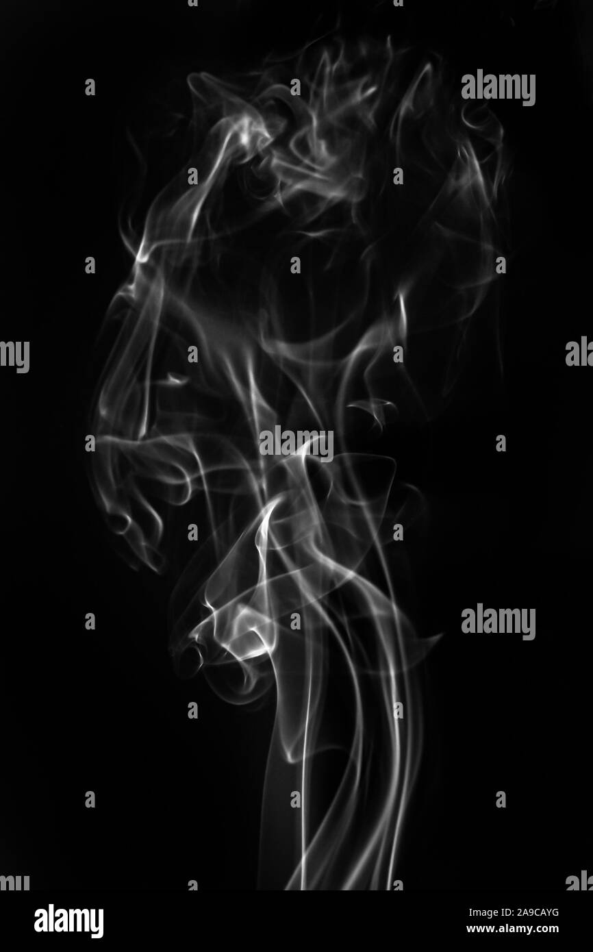 Gray smoke on a black background. Realistic incense smoke captured with ...