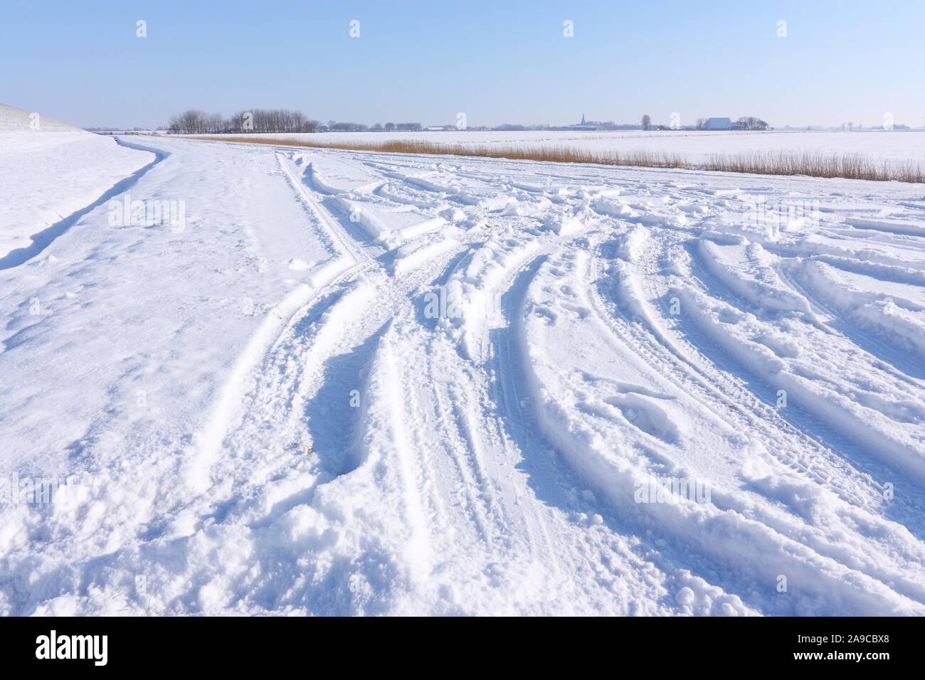 Car tire tracks in a winter snow landscape Stock Photo - Alamy