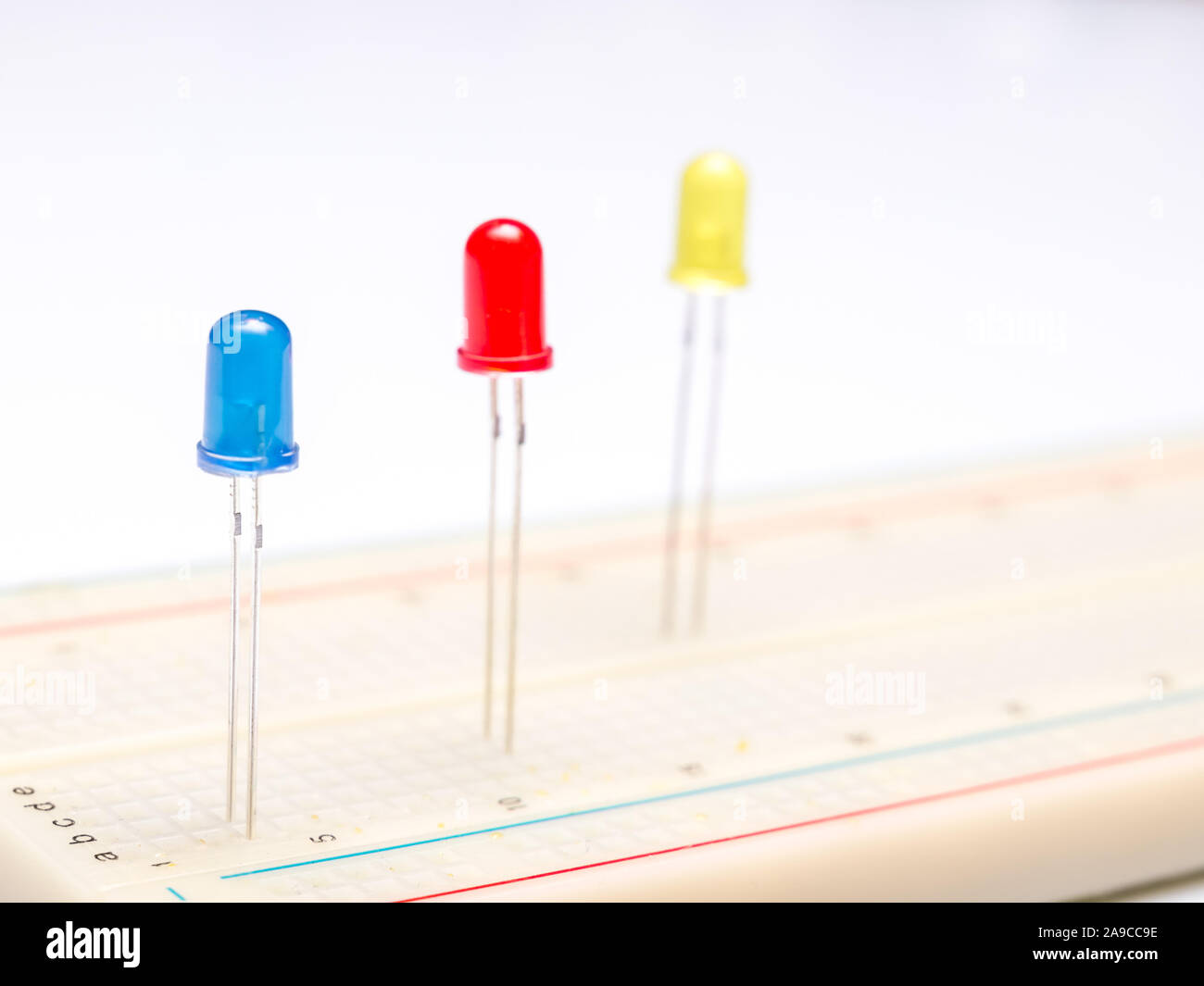 three color leds in breadboard isolated in white background. Close up ...