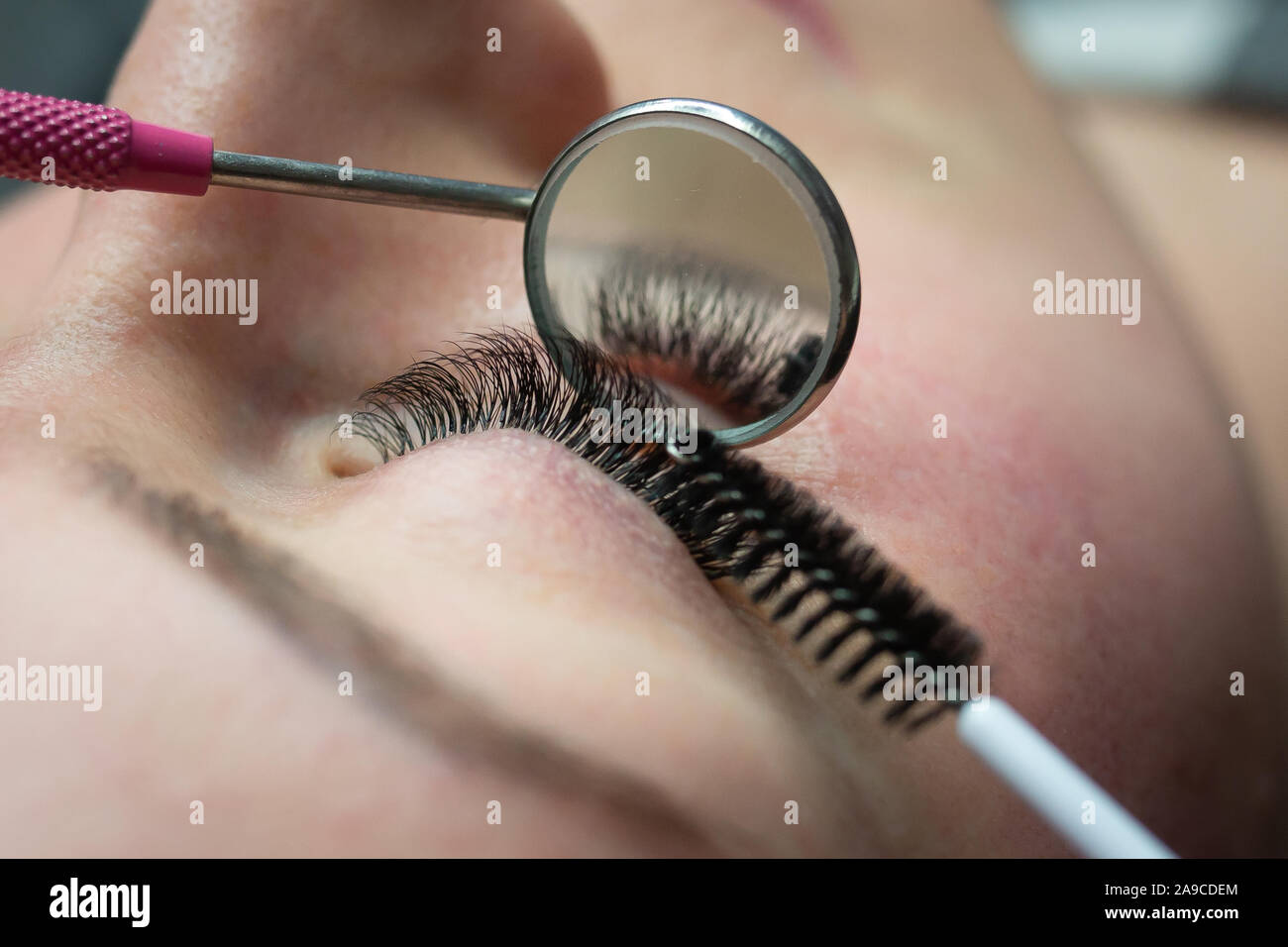 Woman getting a beautiful eyelashes extensions Stock Photo - Alamy