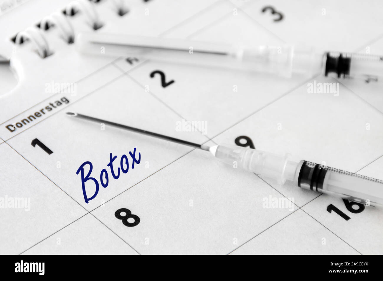 Botox and injection against German calendar Stock Photo - Alamy
