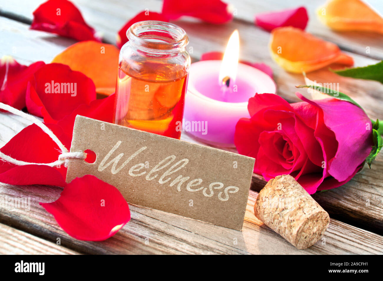 Wellness oil and roses with label Stock Photo - Alamy