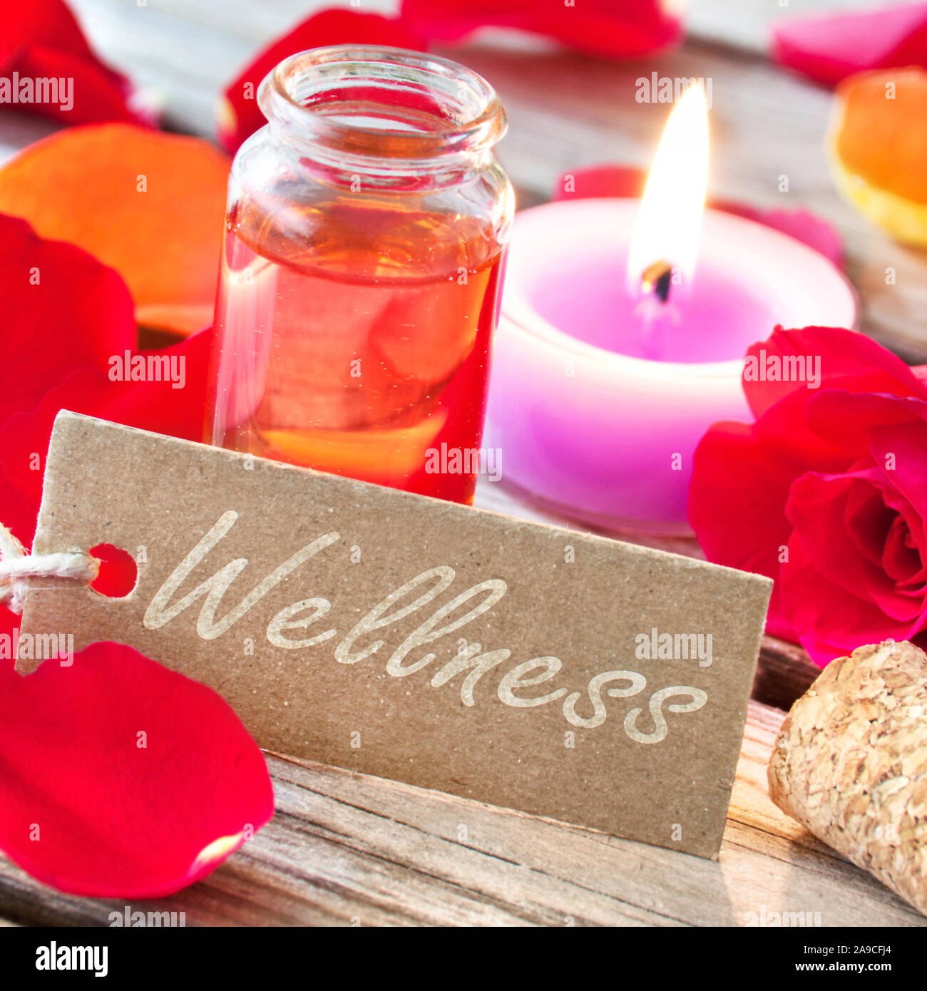 Wellness oil and roses with label Stock Photo - Alamy