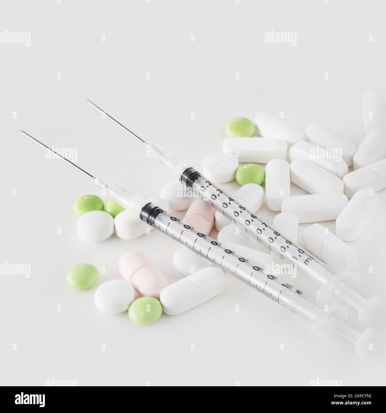 Medicine injections and pills on white background Stock Photo - Alamy