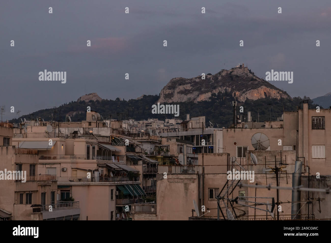 Television antennas over Athens buildings with Lycabettus mountain in background, Athens, Greece ...
