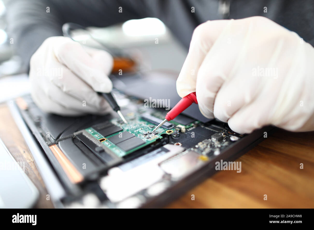 Technician soldering laptop board Stock Photo - Alamy