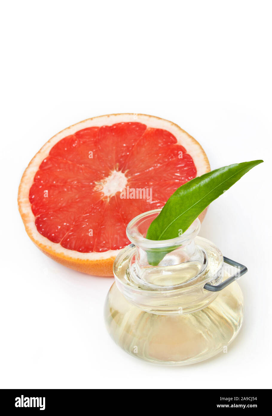 Pink Grapefruit oil and fruit on white background Stock Photo - Alamy
