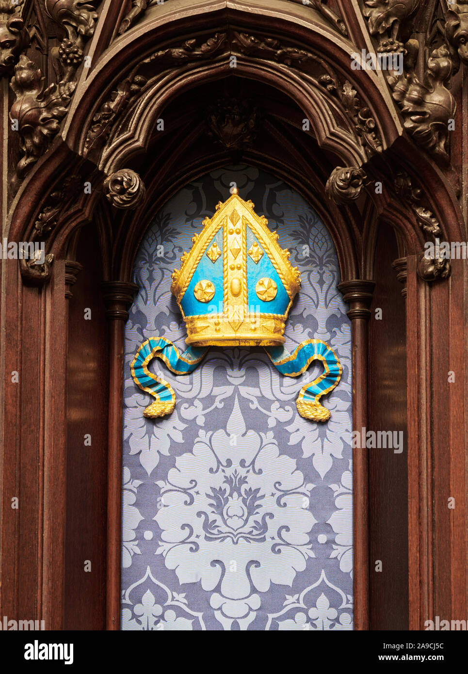 Mitre on the bishop's chair in the choir at the english medieval ...