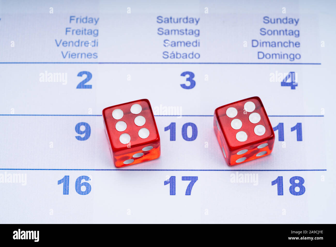 An Overhead View Of Two Transparent Red Dice On Calendar's Date Stock ...