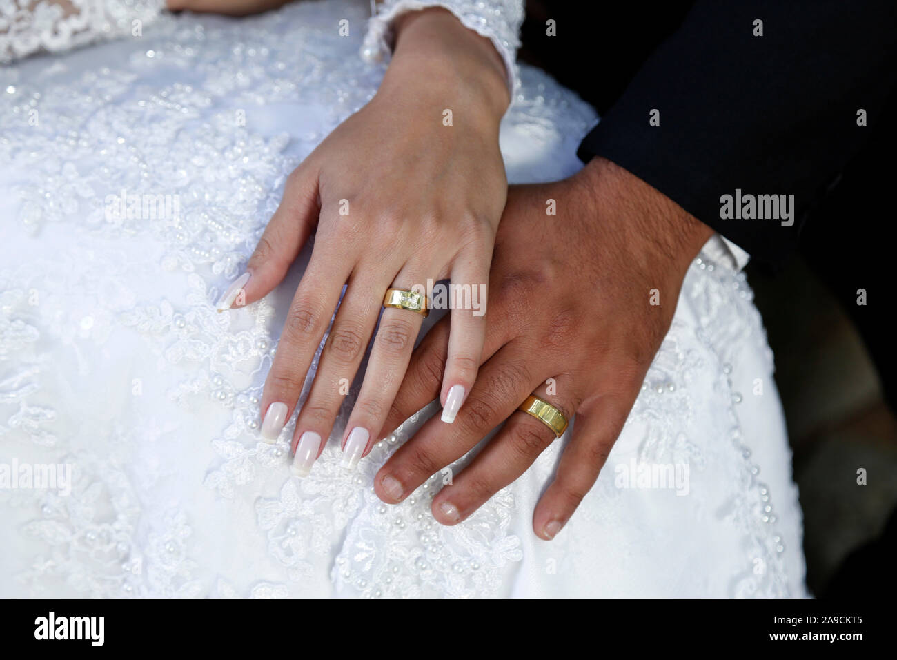 United hands and wedding rings, detail of hands of bride and groom ...