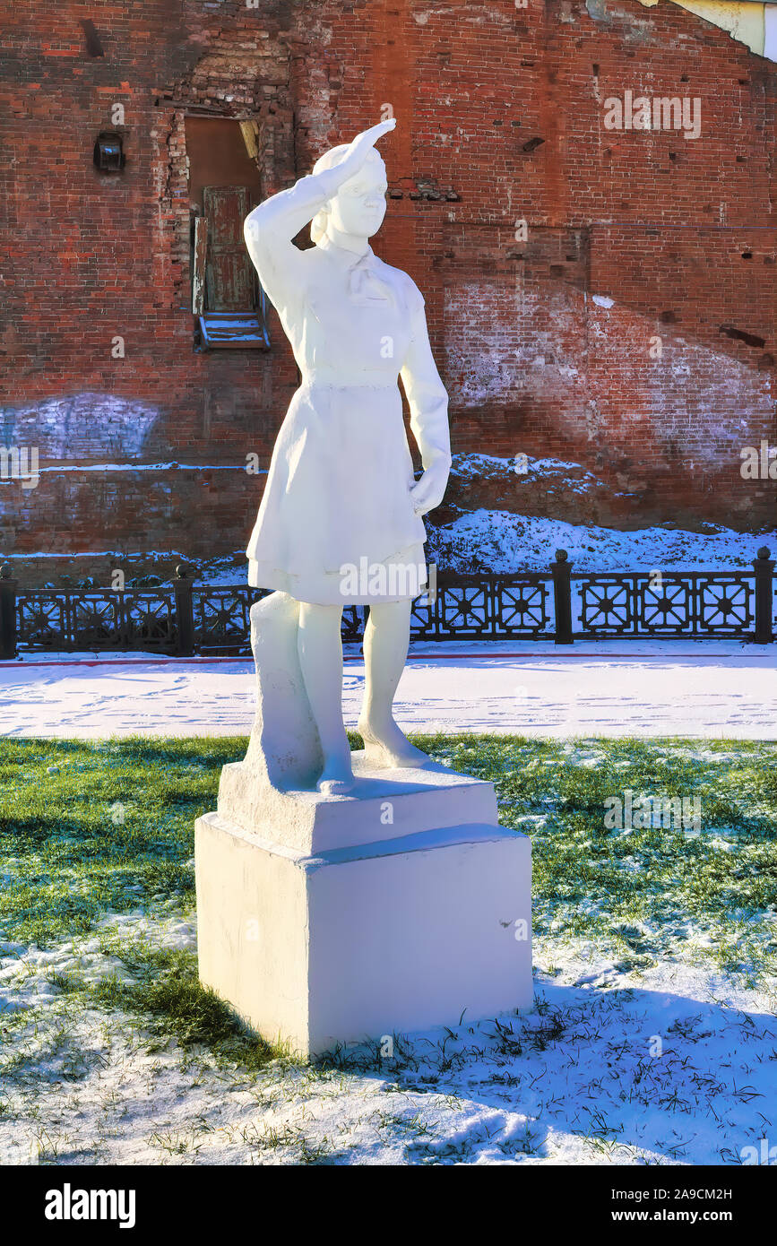 Old Soviet park sculpture on a background of an old red brick building ...
