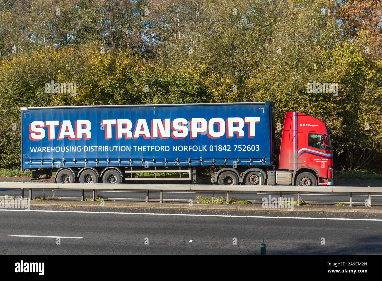 Star Transport lorry or truck driving along a dual carriageway, UK ...