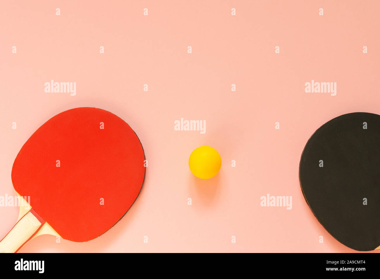 Black and red tennis ping pong rackets and orange ball isolated on a ...