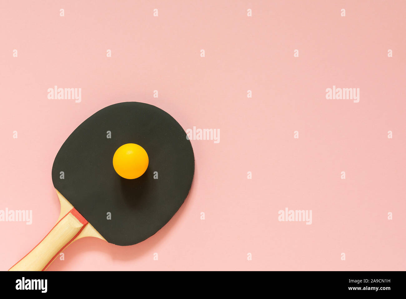 Black tennis ping pong racket isolated on a pink background, sport ...