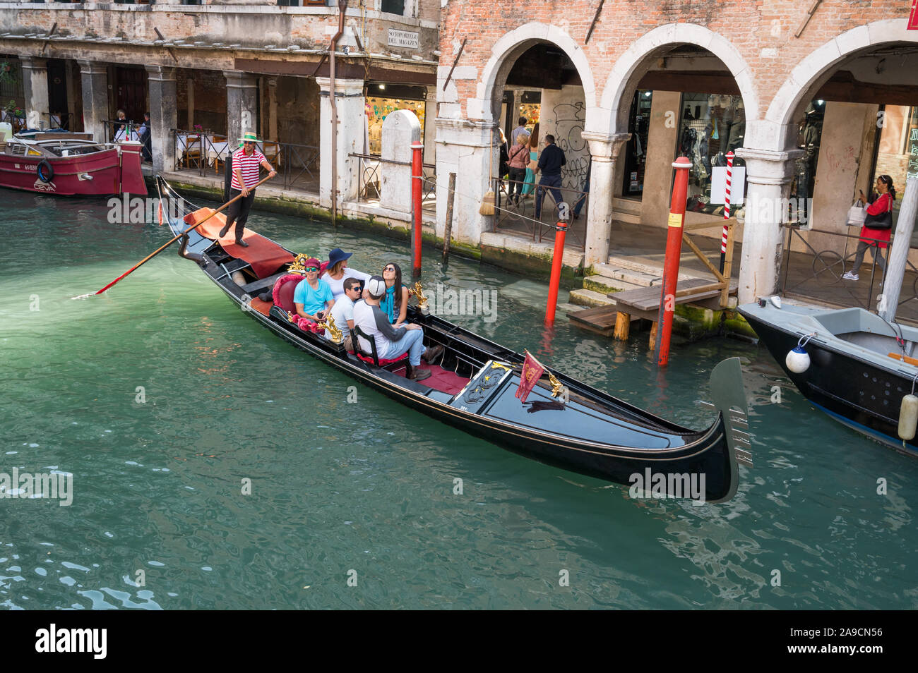 Riding a gondola through the canals of Venice, Italy Stock Photo - Alamy