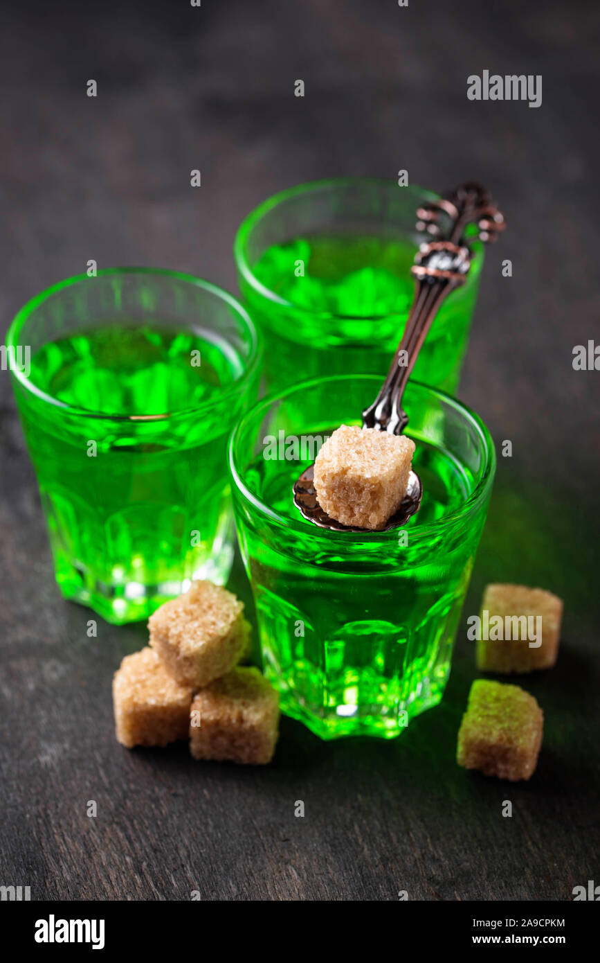 Glasses of absinthe with brown sugar Stock Photo - Alamy
