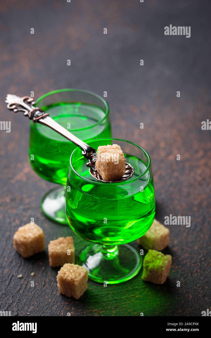 Glasses of absinthe with brown sugar Stock Photo - Alamy