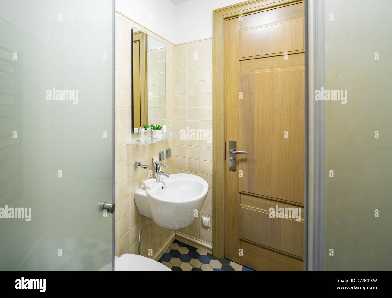 Bathroom with shower cabin. Tile floor and walls Stock Photo - Alamy