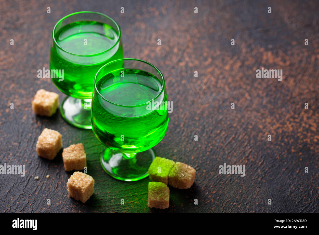 Glasses of absinthe with brown sugar Stock Photo - Alamy