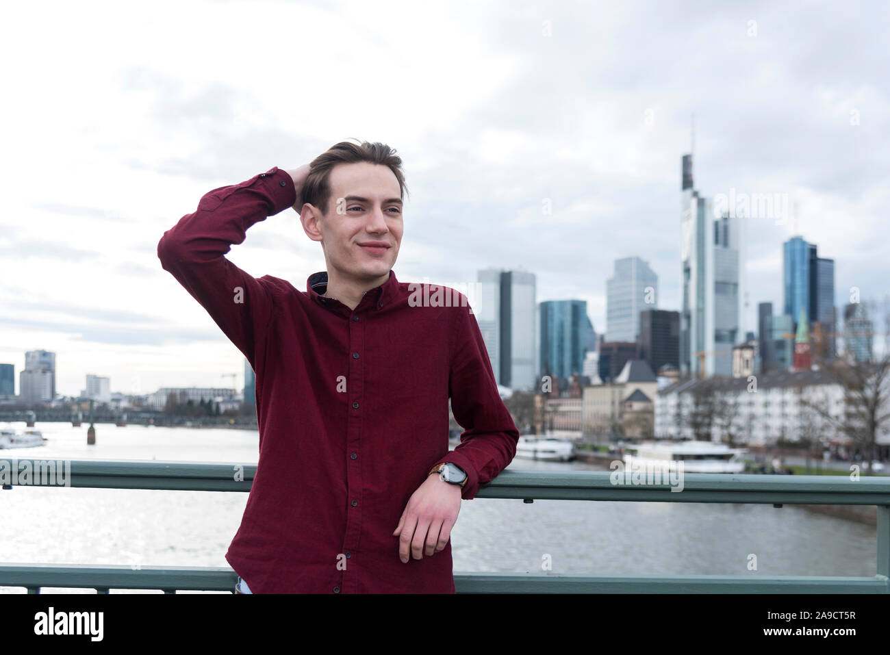 Man, young, bridge railing, leaning, half portrait Stock Photo - Alamy