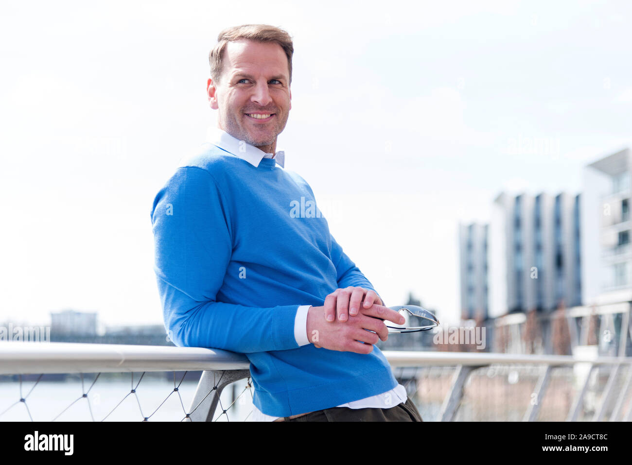 Men lean against railing outside hi-res stock photography and images ...