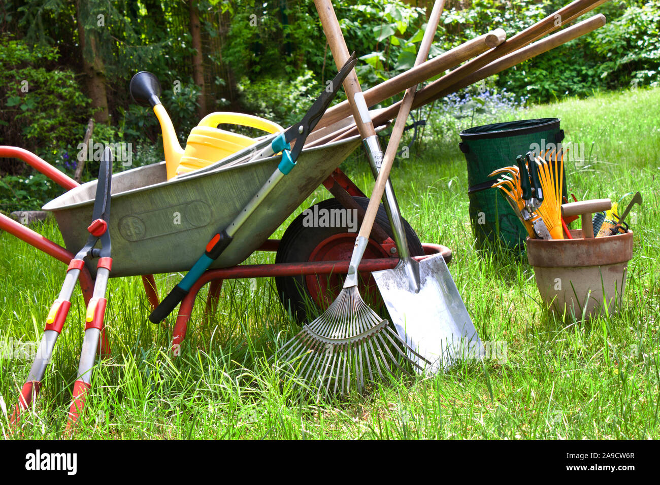 Various gardening tools in the garden Stock Photo - Alamy