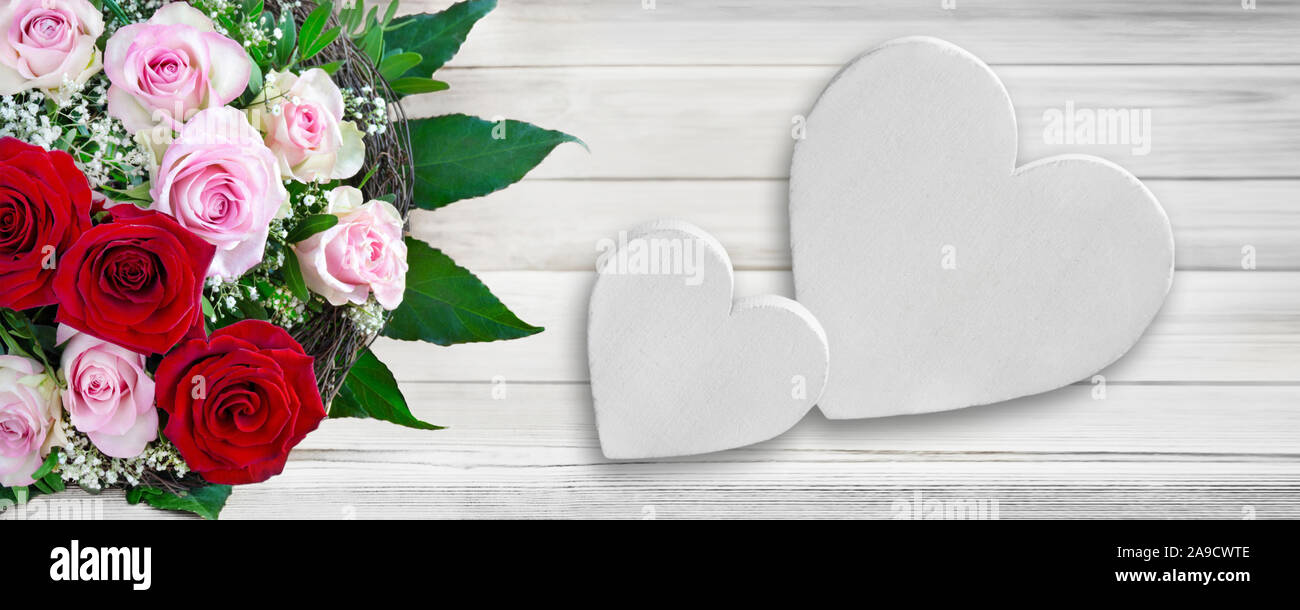 Red and pink roses and two hearts Stock Photo - Alamy