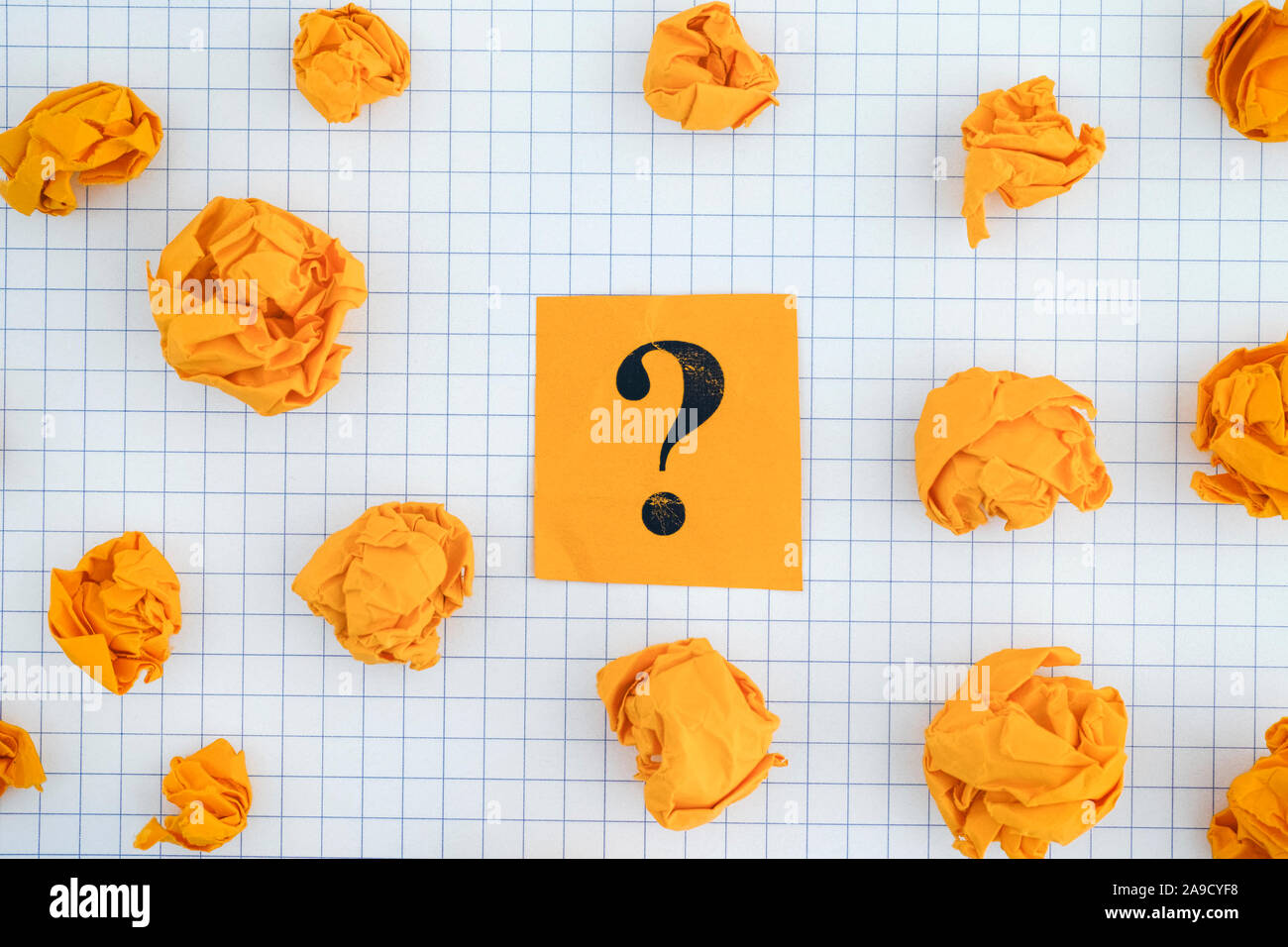 Yellow paper note with question mark on notebook sheet with some yellow ...