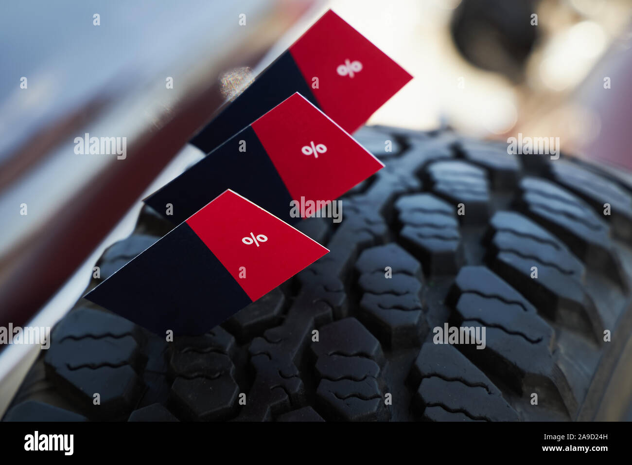 Cardboard cards with written percent discount for buying car tires ...