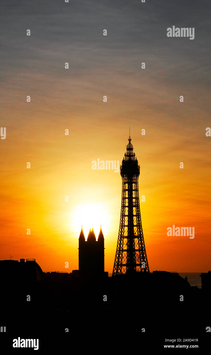 Blackpool Tower and St Johns Church tower shown in silhouette against a ...