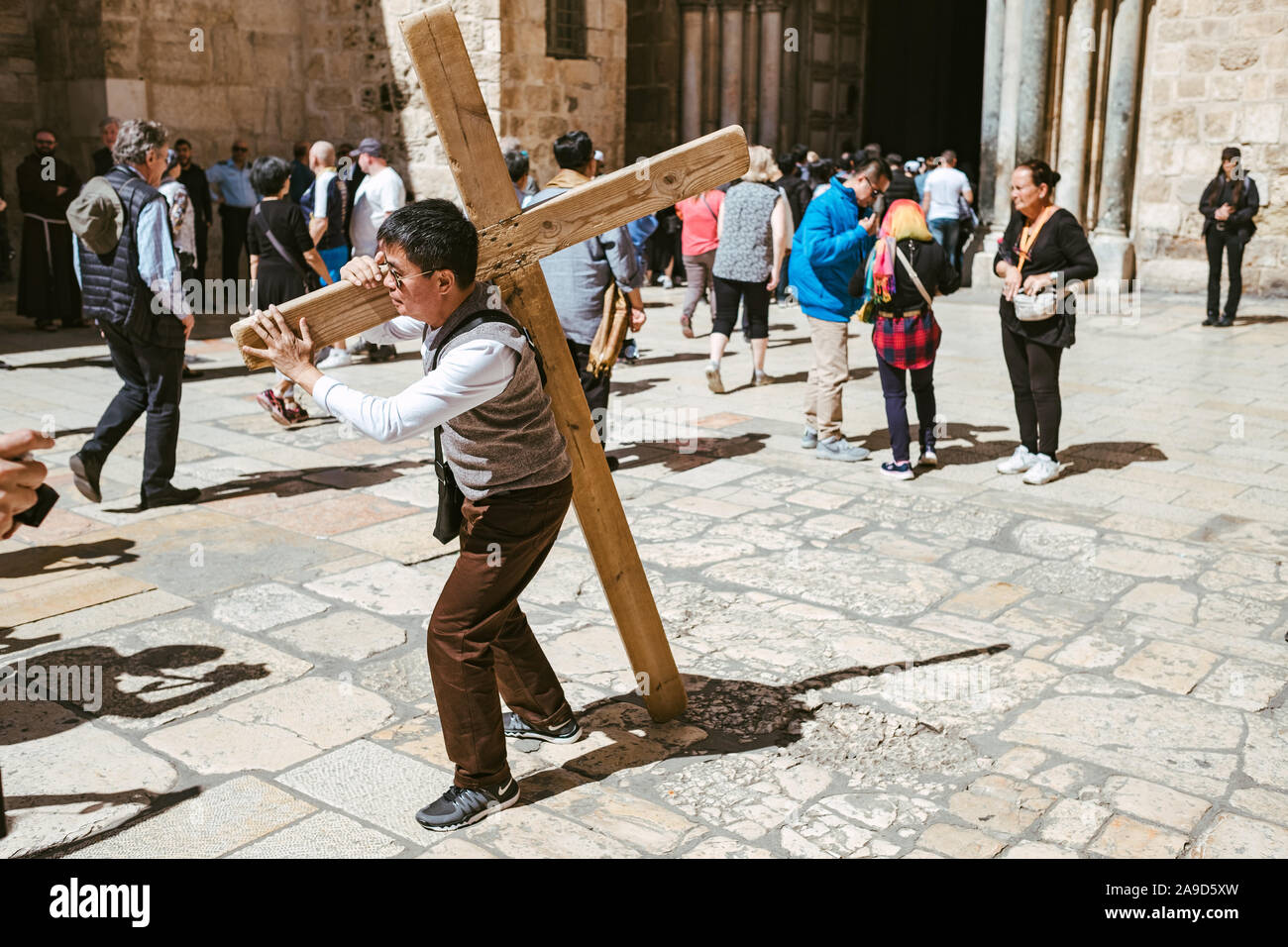 Chinese tourist posing with a cross in Jerusalem, Church of the Holy ...