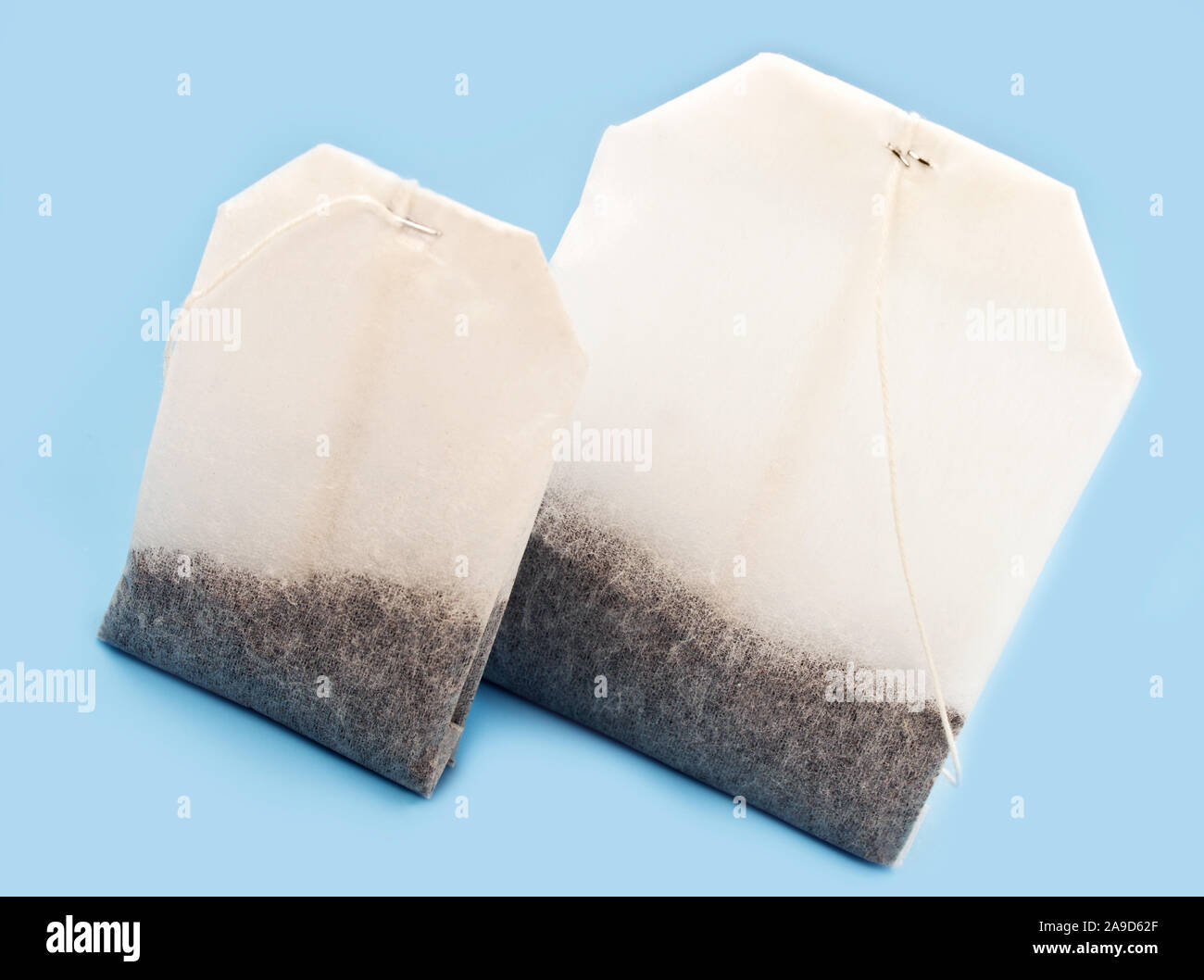 Two tea bags and blue background Stock Photo - Alamy