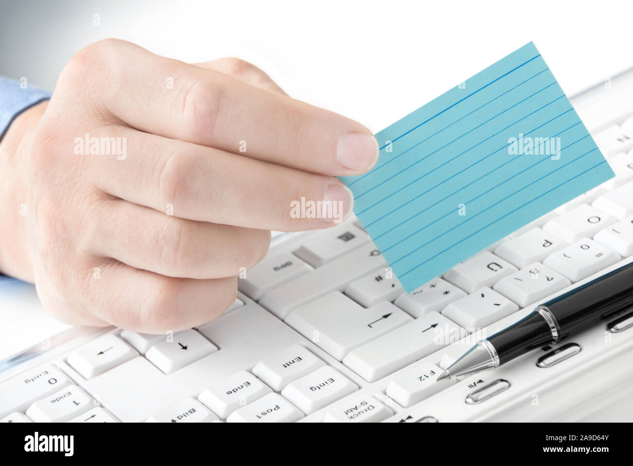 Male hand and blue label Stock Photo - Alamy