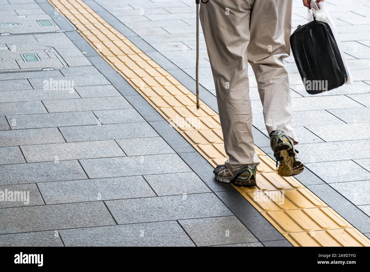 Person walking on tactile paving hi-res stock photography and images ...