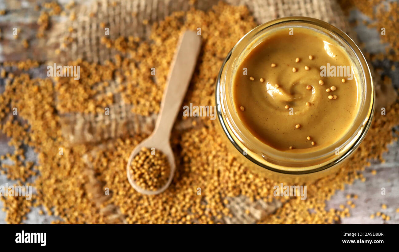 Natural mustard in a jar. Grains of mustard. Homemade mustard. Organic ...