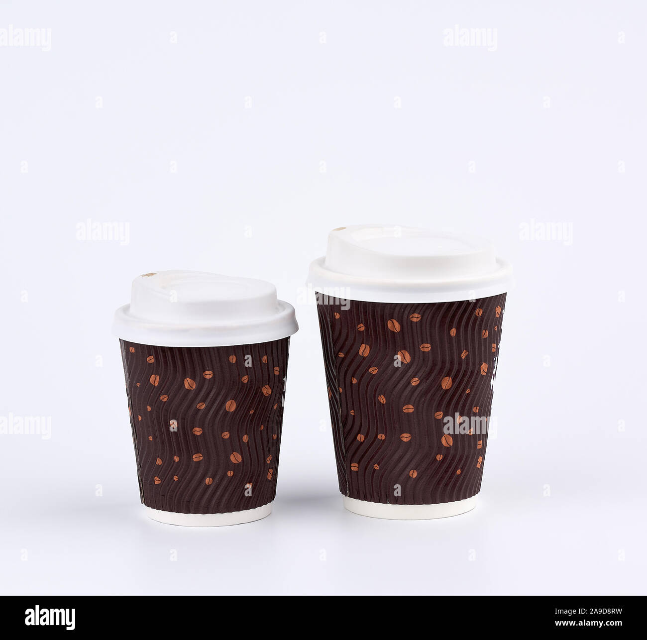 used brown paper cup with plastic cover for hot and cold drinks on a ...