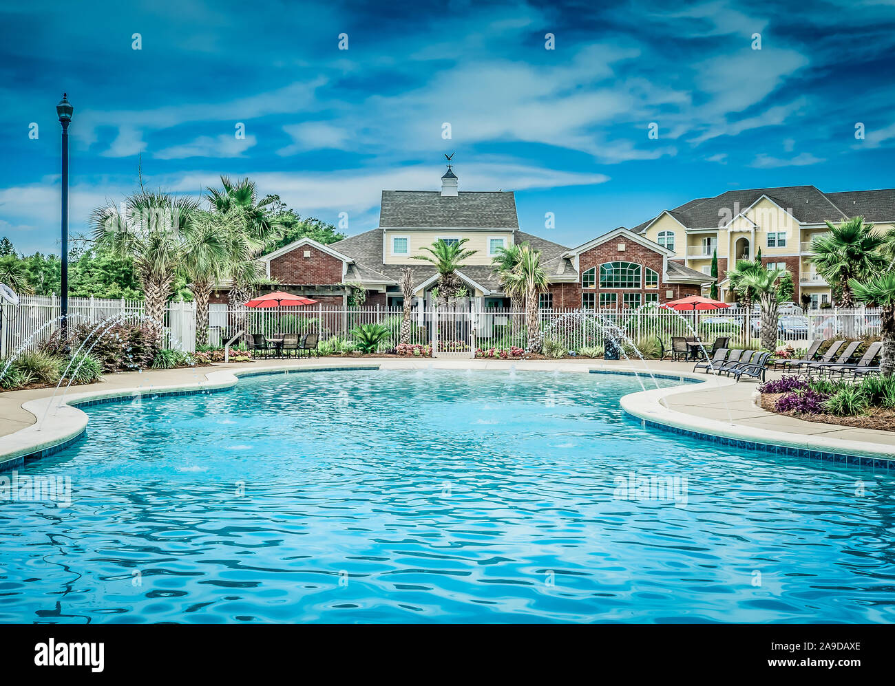 A large, curvy built-in zero entry swimming pool is a focal point for ...