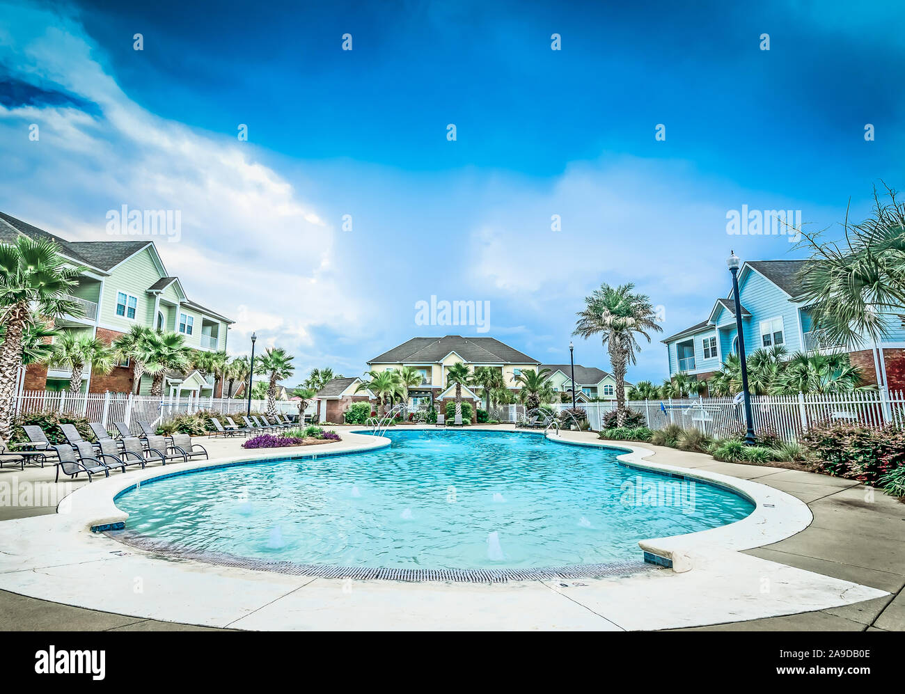 A large, curvy built-in zero entry swimming pool is a focal point for ...