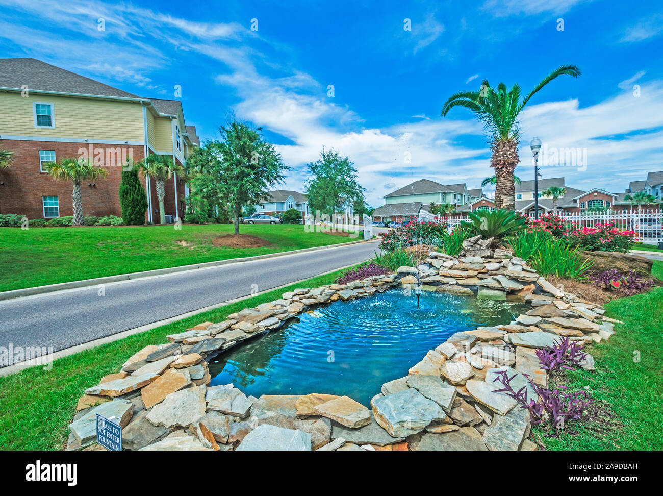 A small pond beautifies the entrance to Cypress Cove Apartment Homes in ...