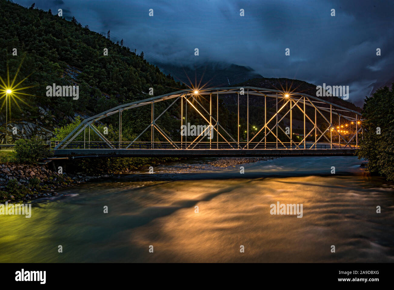 Steel bridge over river at night Stock Photo - Alamy