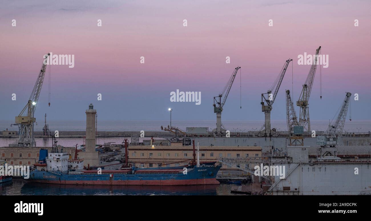 Entering the harbour of Palermo after sunset, port facilities, docks ...