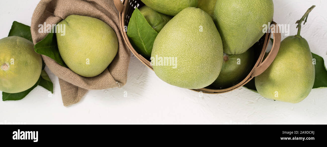 Fresh pomelo, pummelo, grapefruit, shaddock on white cement background ...