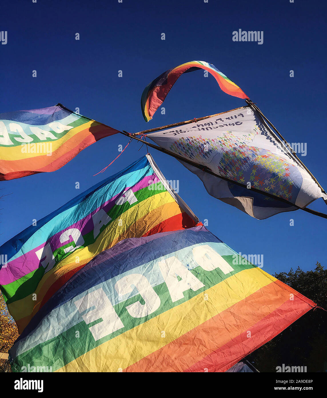 Waving Peace Flags in front of blue sky Stock Photo - Alamy