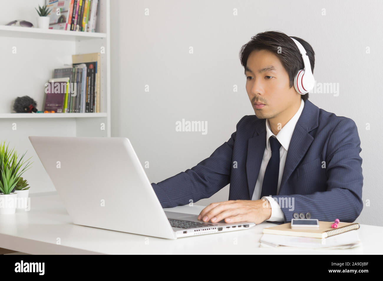 Asian Man Call Center in Suit Wear Headset or Headphone Contacting and ...