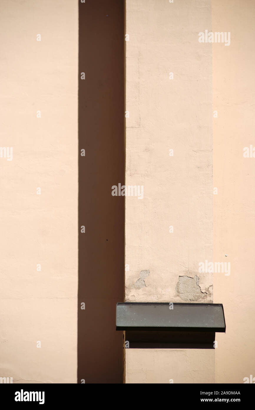An angular column on a smooth facade casting a shadow Stock Photo - Alamy