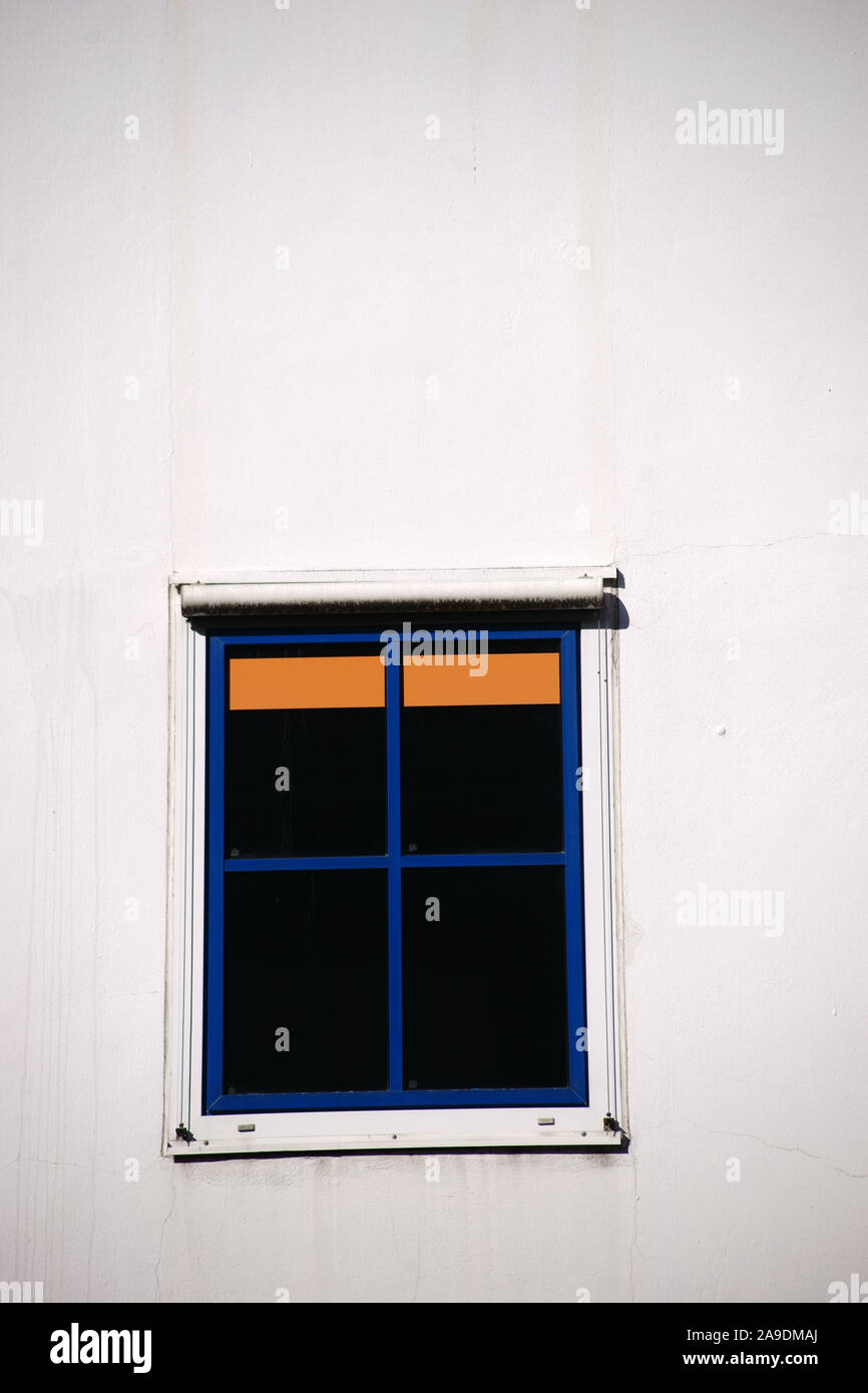 An abstract window with blue window frame and orange venetian blind in ...