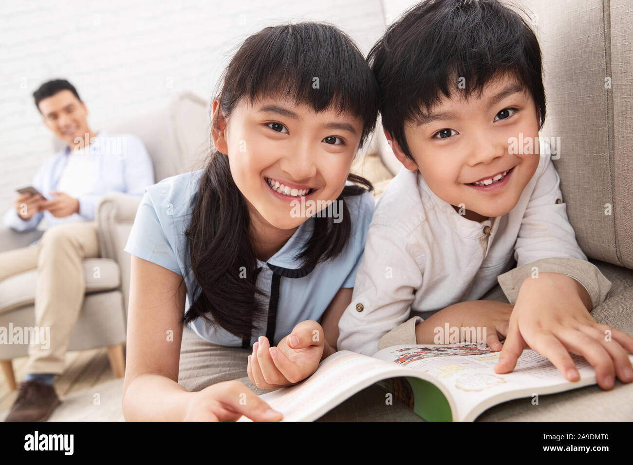 Siblings, two people reading Stock Photo - Alamy