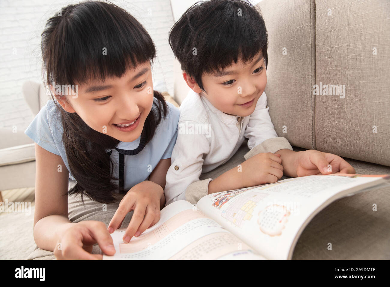 Siblings, two people reading Stock Photo - Alamy