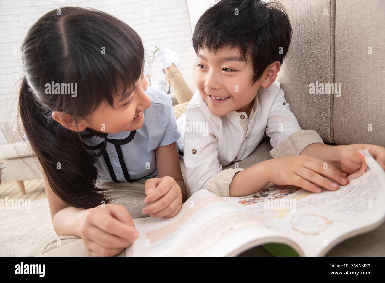 Siblings, two people reading Stock Photo - Alamy