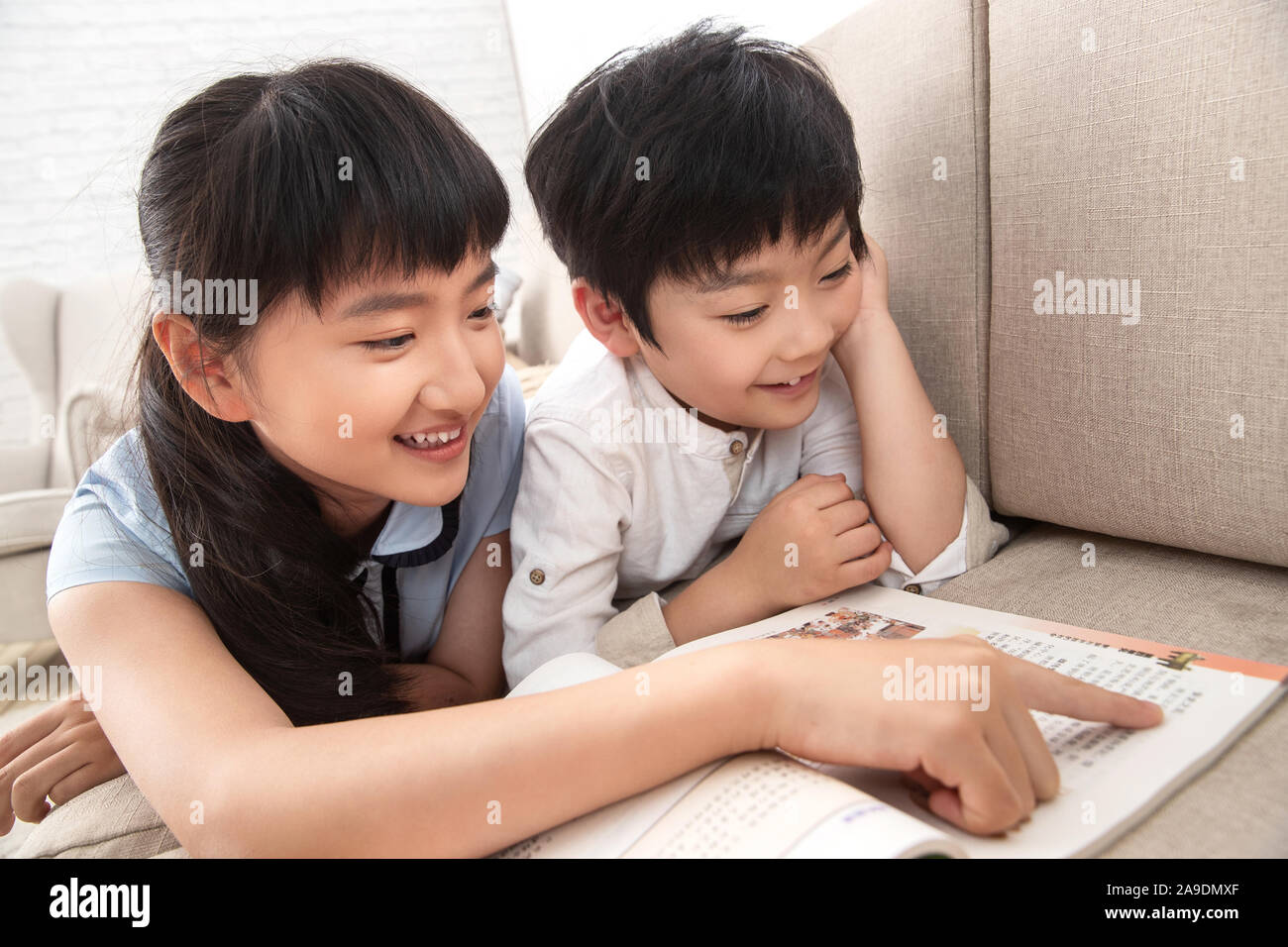 Siblings, two people reading Stock Photo - Alamy